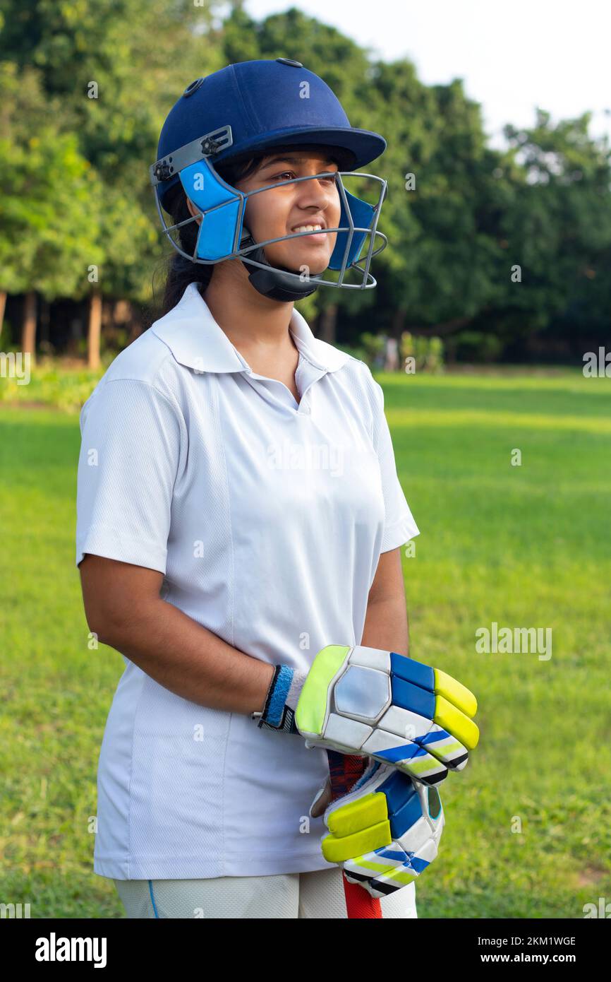 Portrait of a young cricket girl in cricket helmet Stock Photo - Alamy