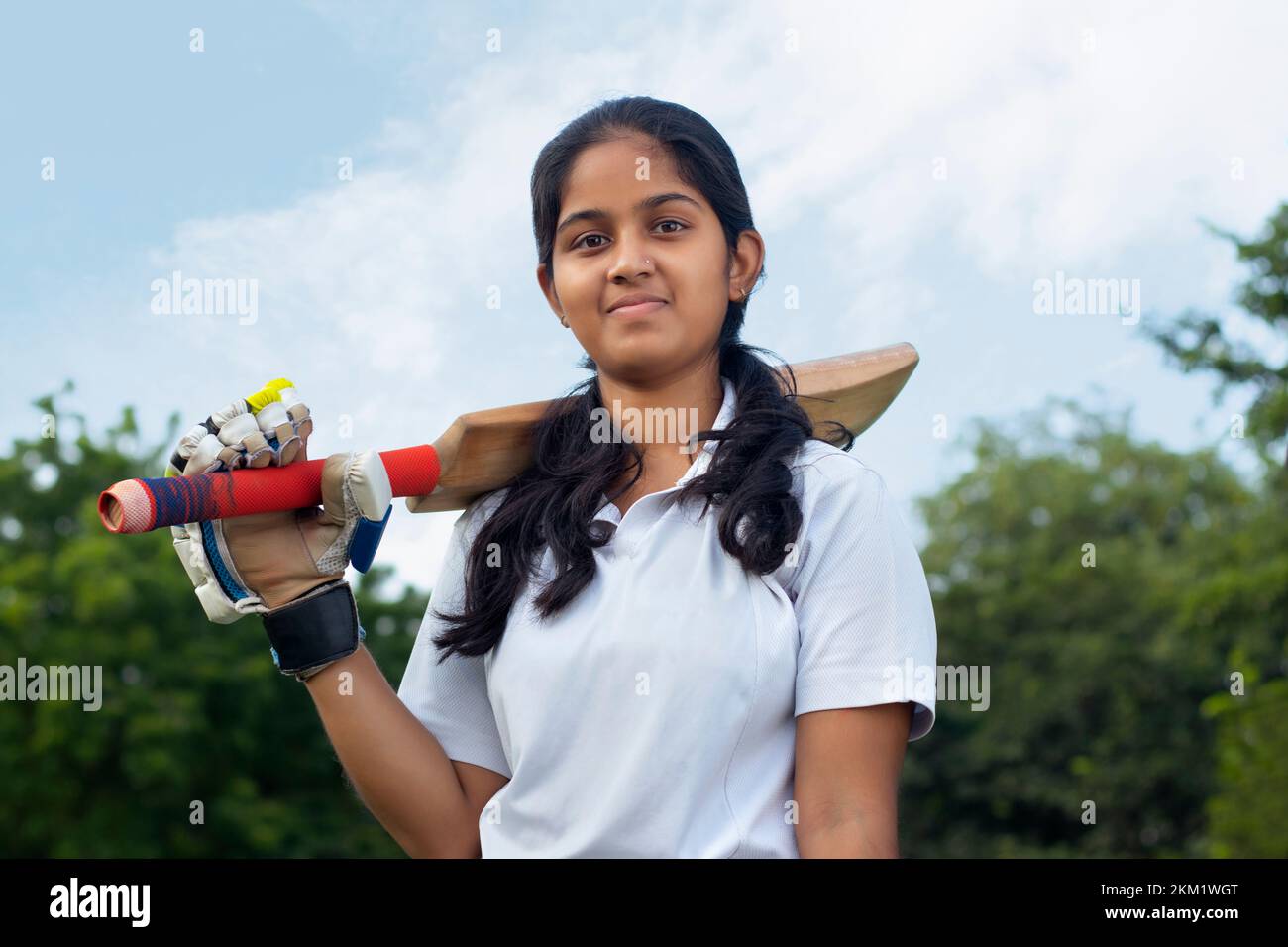 Portrait Of A Female Cricketer Holding A Cricket Bat Stock Photo - Alamy