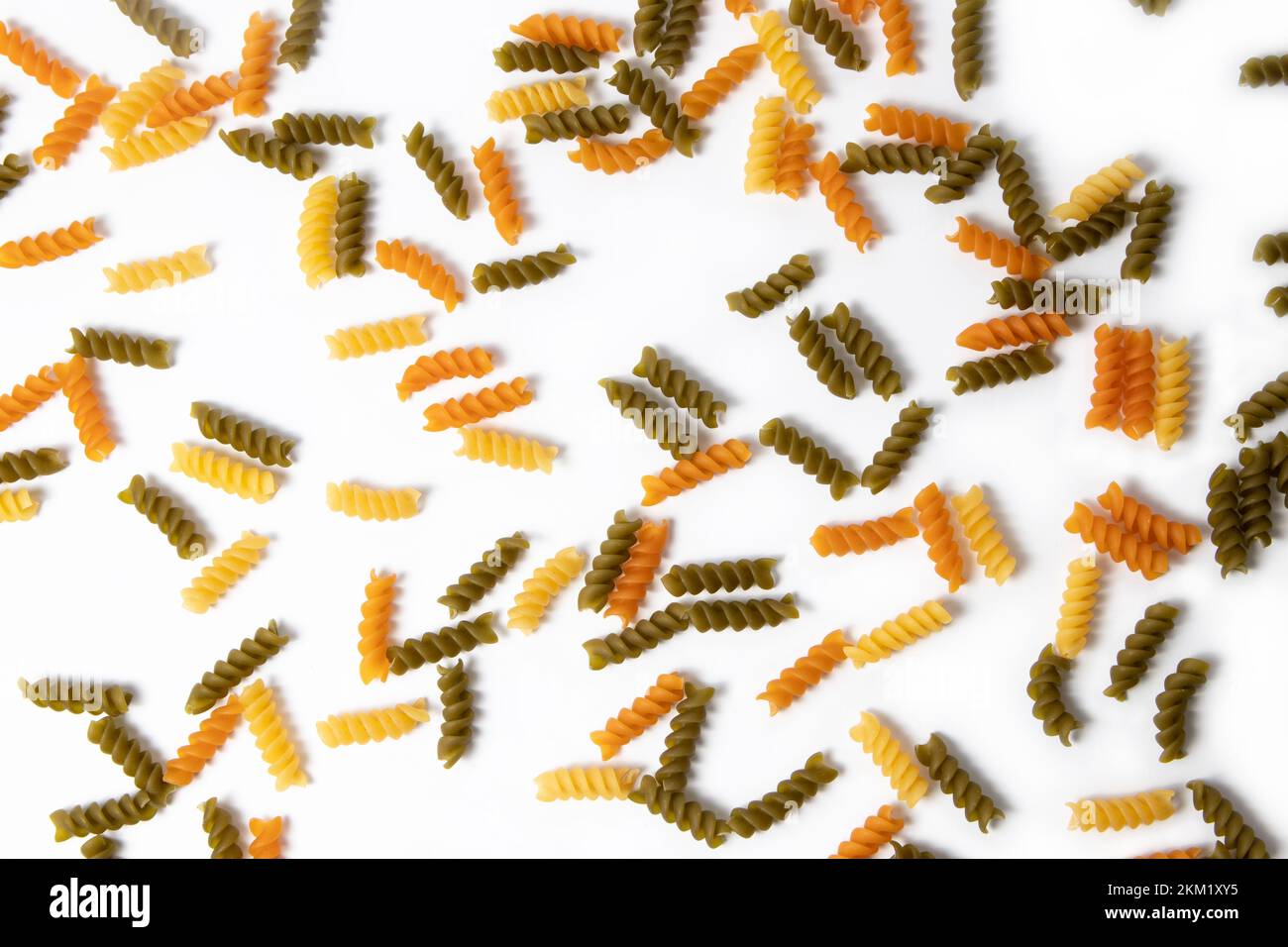 Fusilli pasta in three colors on white background Stock Photo - Alamy