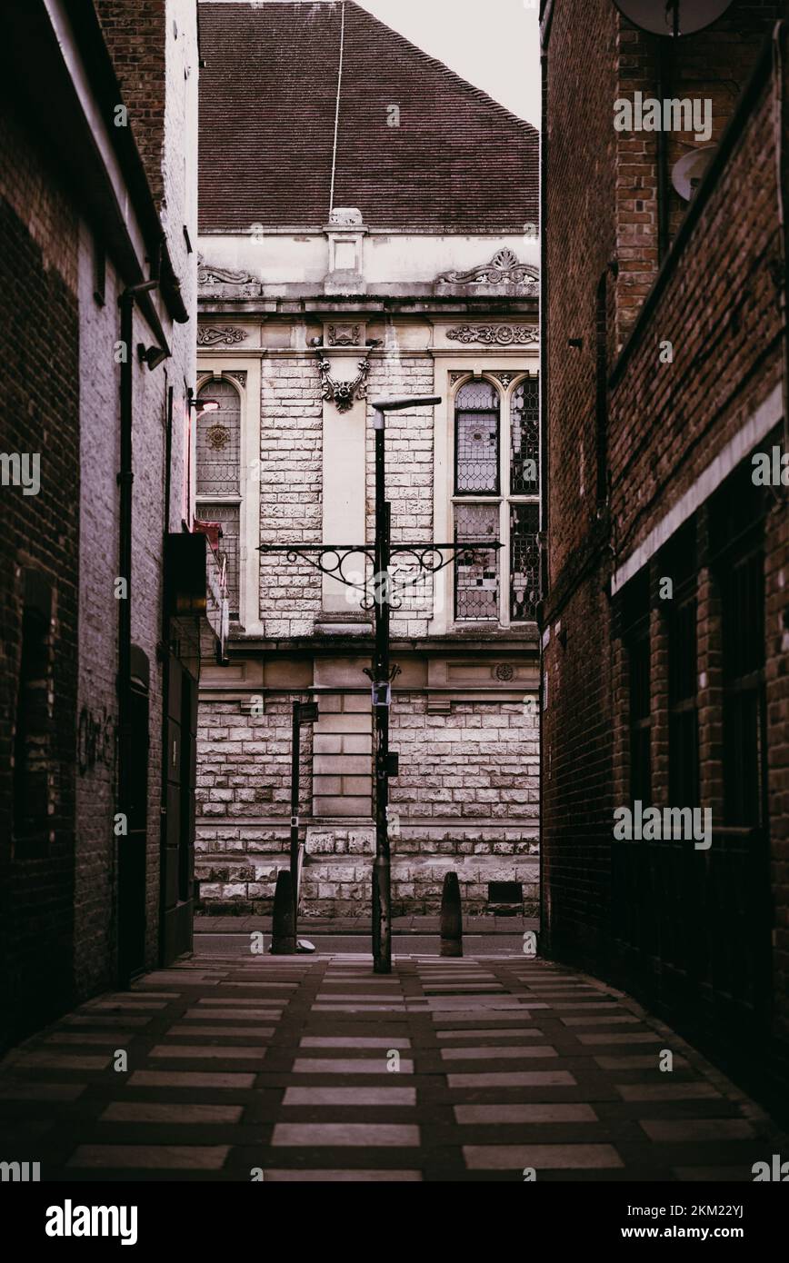 An alley in the city with tall buildings Stock Photo - Alamy