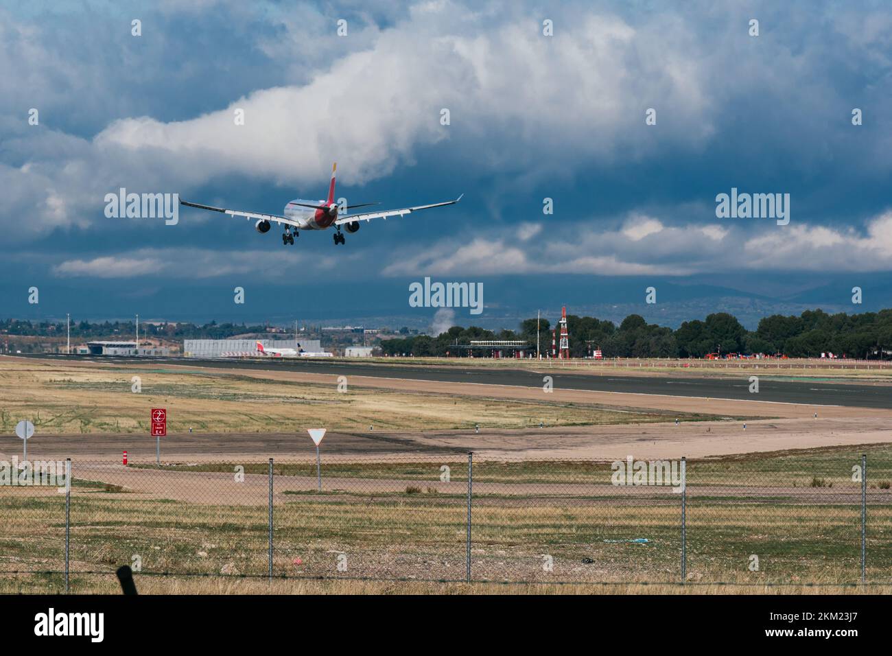 Commercial passenger aircraft landing on the runway of Madrid airport ...