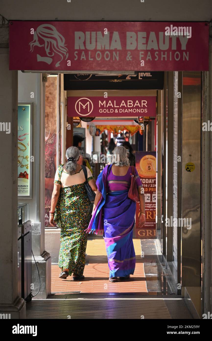 Indian women with colorful saree walking on the streets of Little India ...
