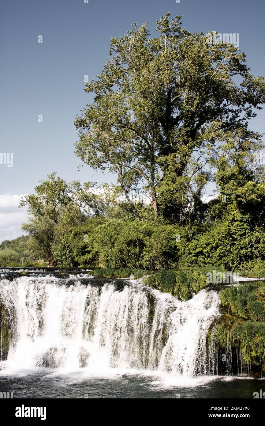 A vertical shot of a beautiful waterfall in the Krka National Park in ...