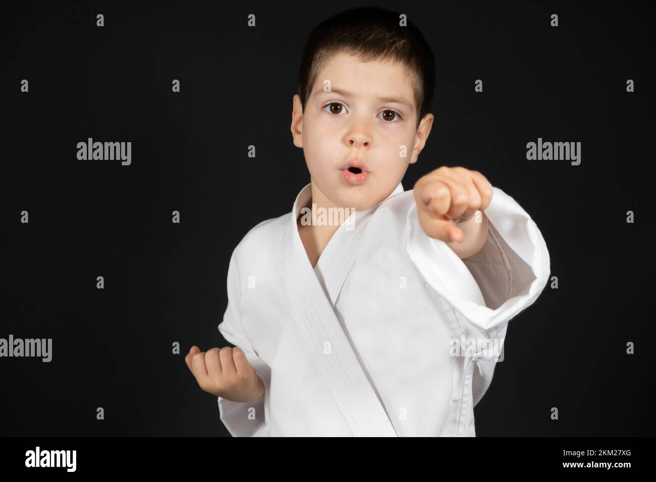 A little boy practices martial arts, karate classes in kimono on a ...