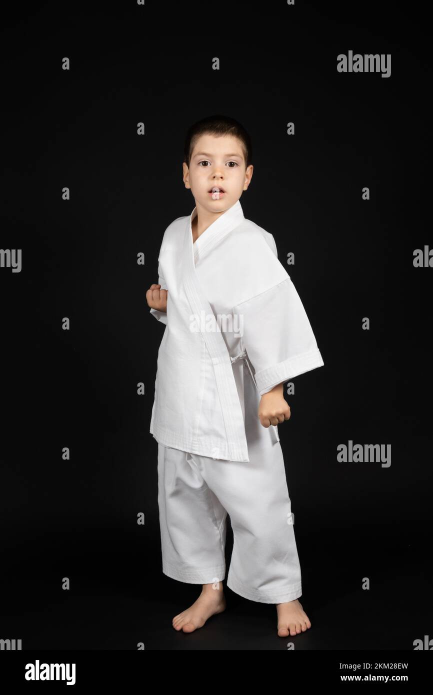 A little boy practices martial arts, karate classes in kimono on a ...