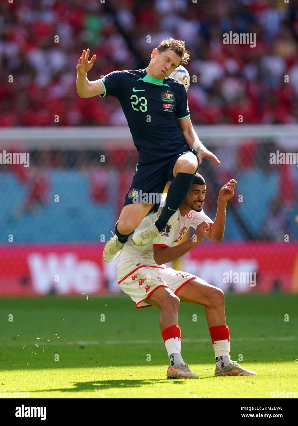 Australia's Craig Goodwin (top) and Tunisia's Mohamed Drager battle for ...