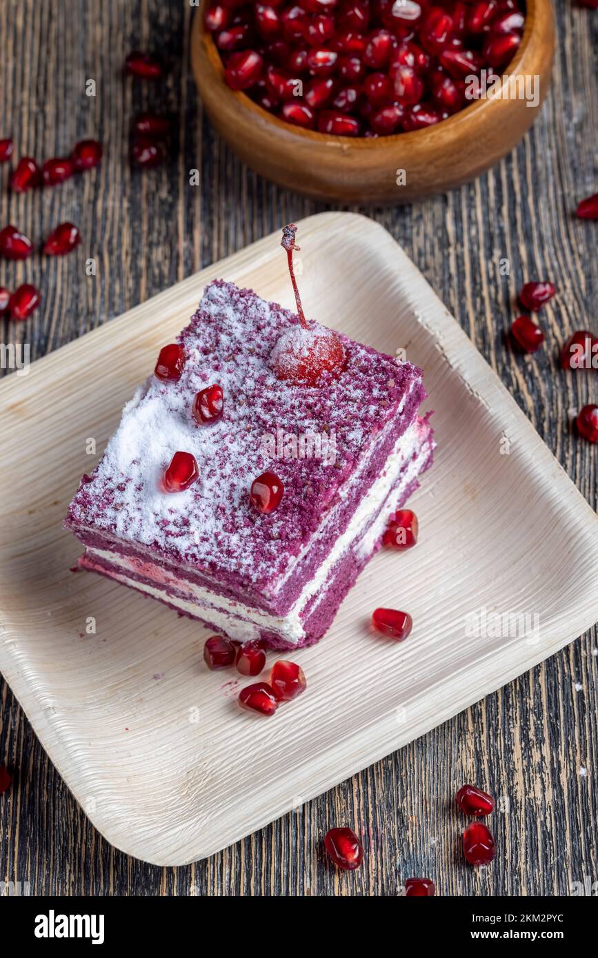 a maroon colored cake with the taste of different berries and a creamy ...