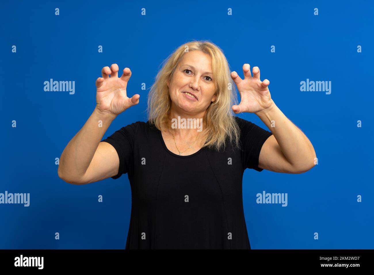 Photo of caucasian attractive blonde woman fooling show fingers claws ...