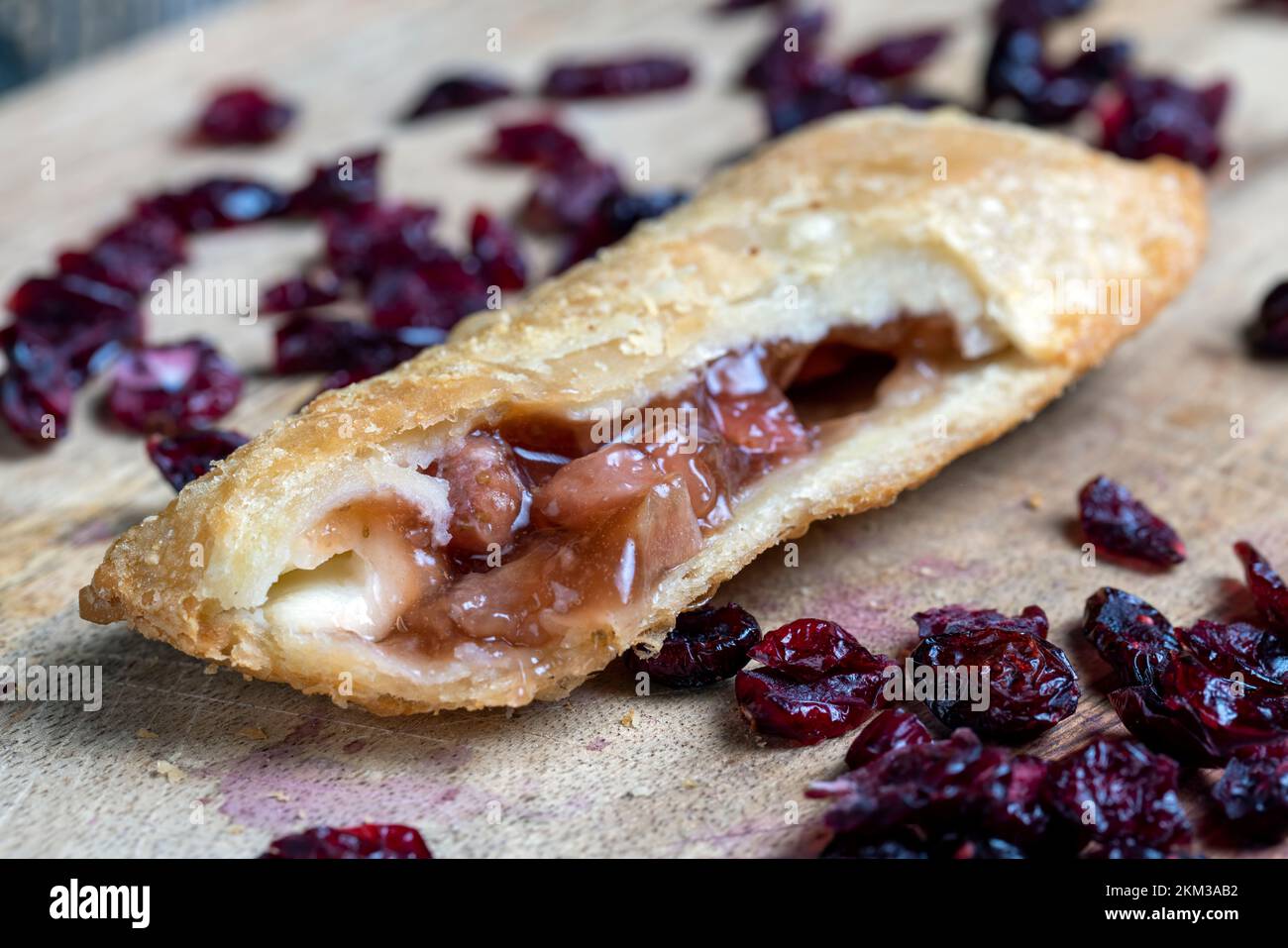 wheat pastries with red cherry strawberry filling on a board, dried ...