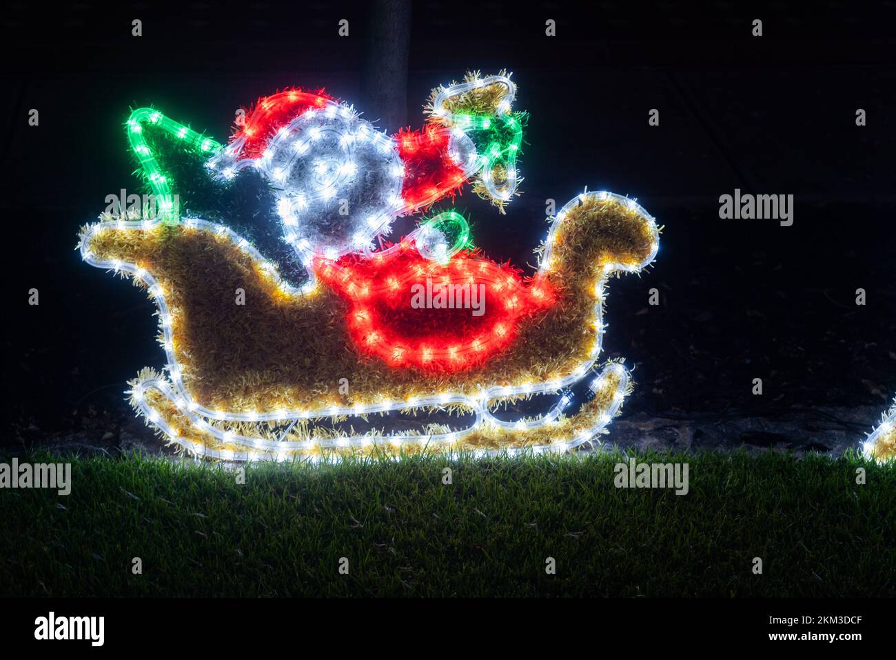 A Santa Claus on a sleigh and reindeer are illuminated on the front ...