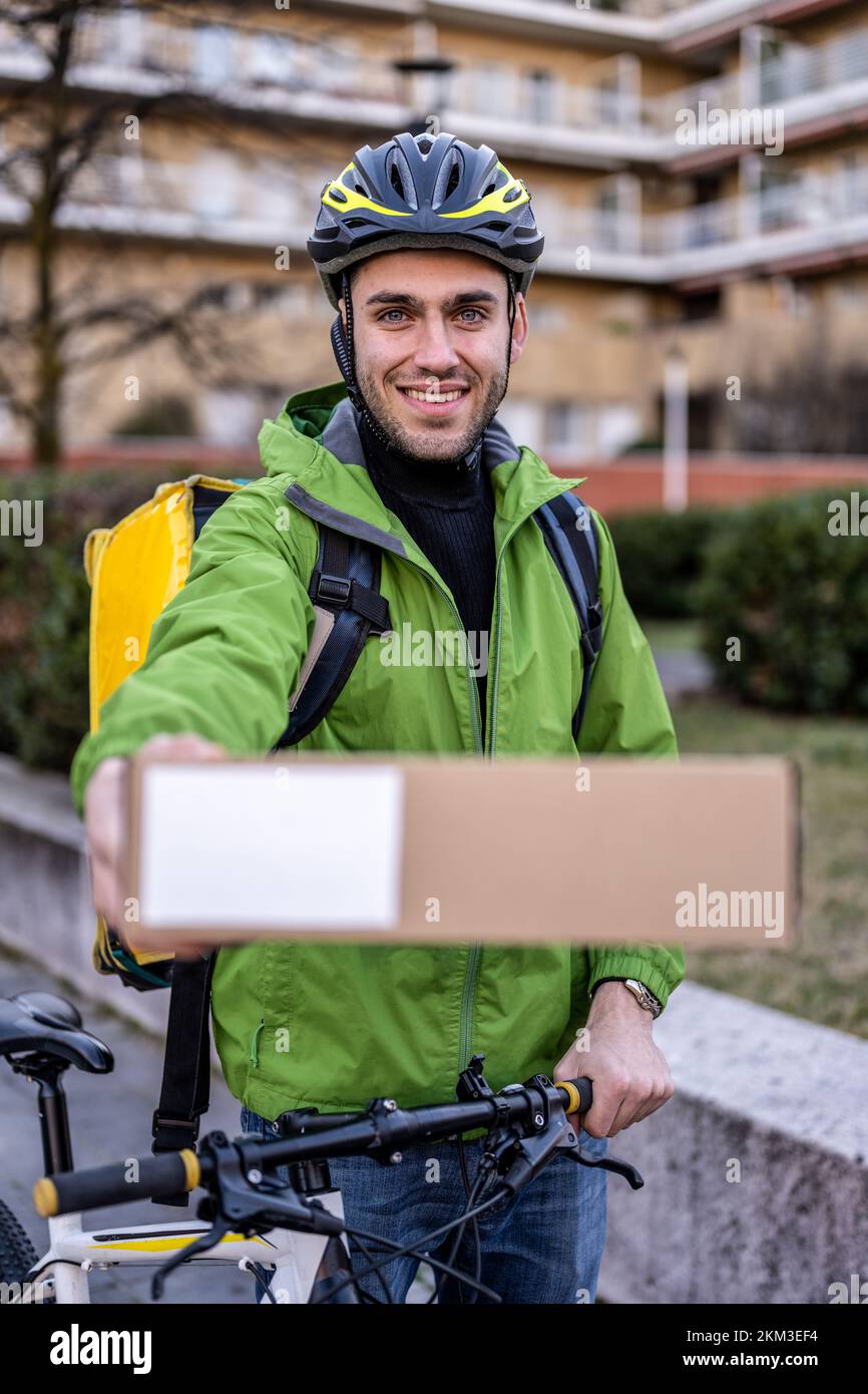 hand delivery to the customer of a package from the deliveryman ...