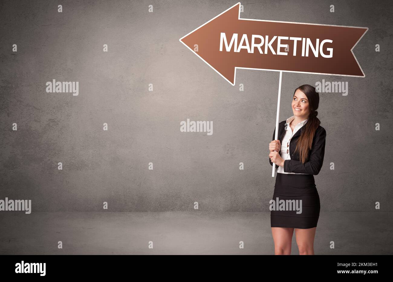 Young business person in casual holding road sign Stock Photo - Alamy