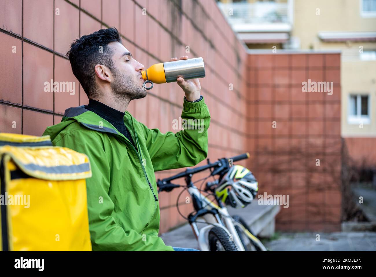 Young delivery man having rest, fast express delivery service worker ...