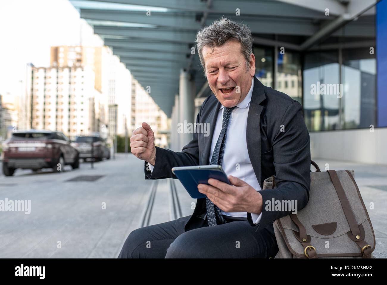 Business man celebrating success looking achievement on tablet, senior ...