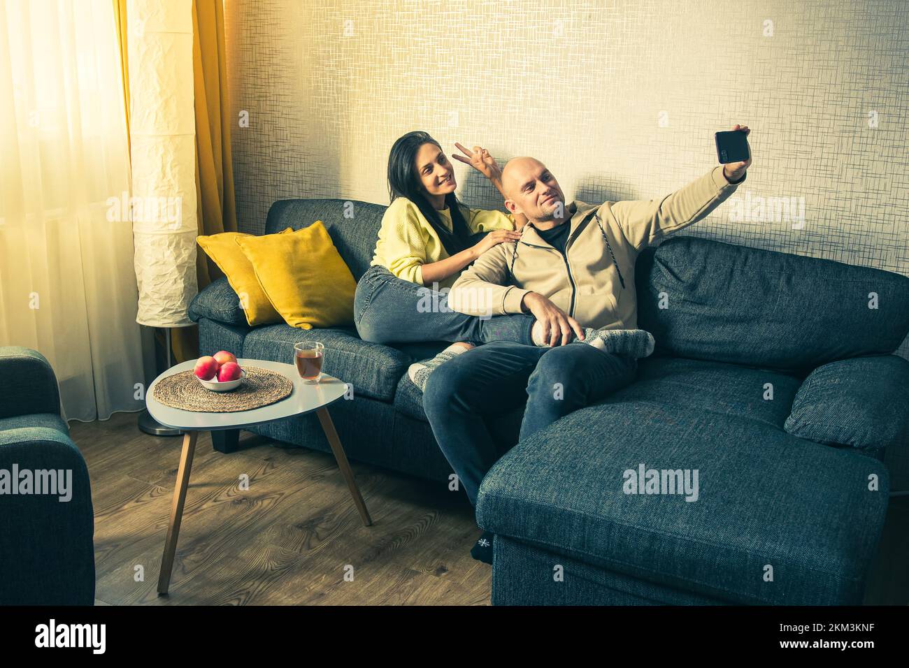 Couple Use Smartphone Device, Sitting on Couch Cozy Apartment. Take ...