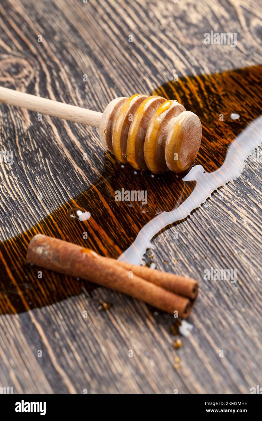 honey spreading on the table, a close up of honey and honey spoons on a ...