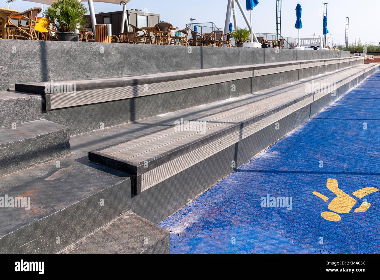 Seating area for spectators made with composite deck next to the tennis ...