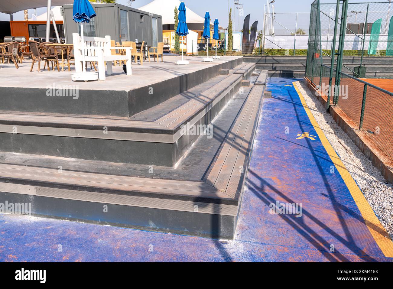 Seating area for spectators made with composite deck next to the tennis ...
