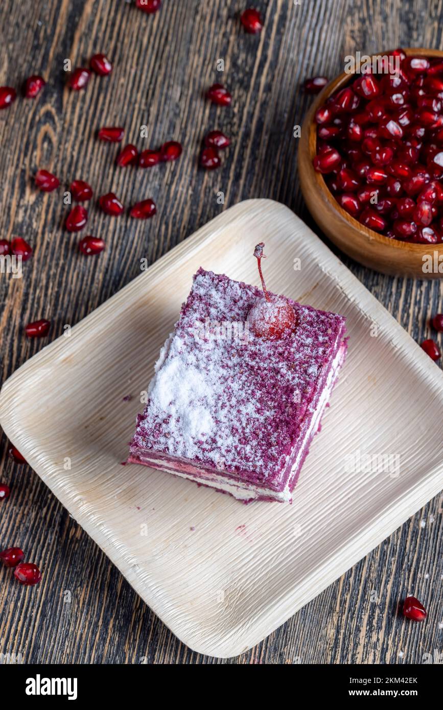 a maroon colored cake with the taste of different berries and a creamy ...