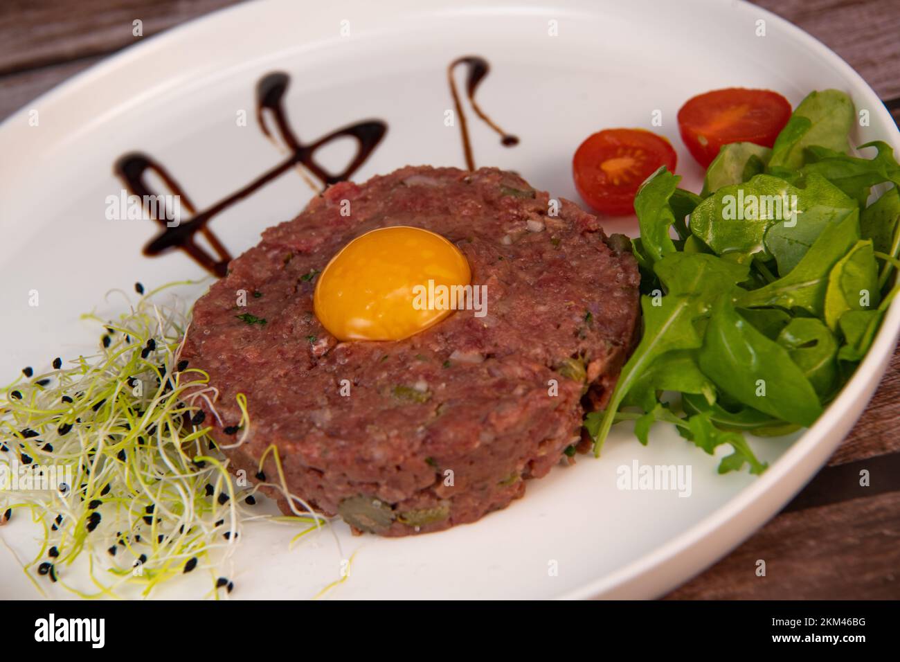 Steak Tartare with vegetables salad and french fries on dish Stock ...