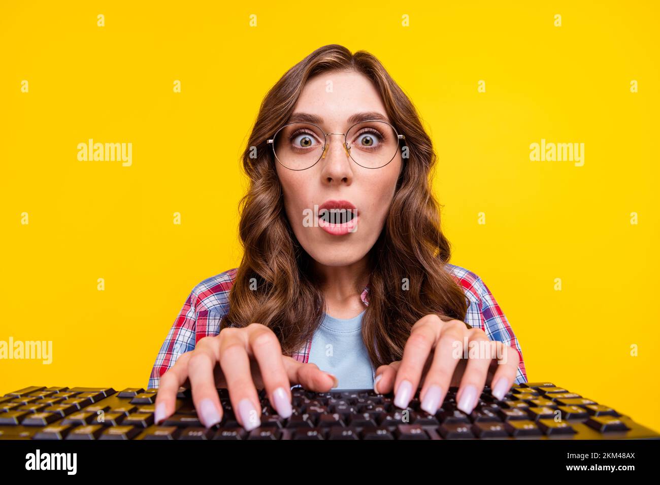 Portrait of excited speechless woman curly hairstyle checkered shirt ...
