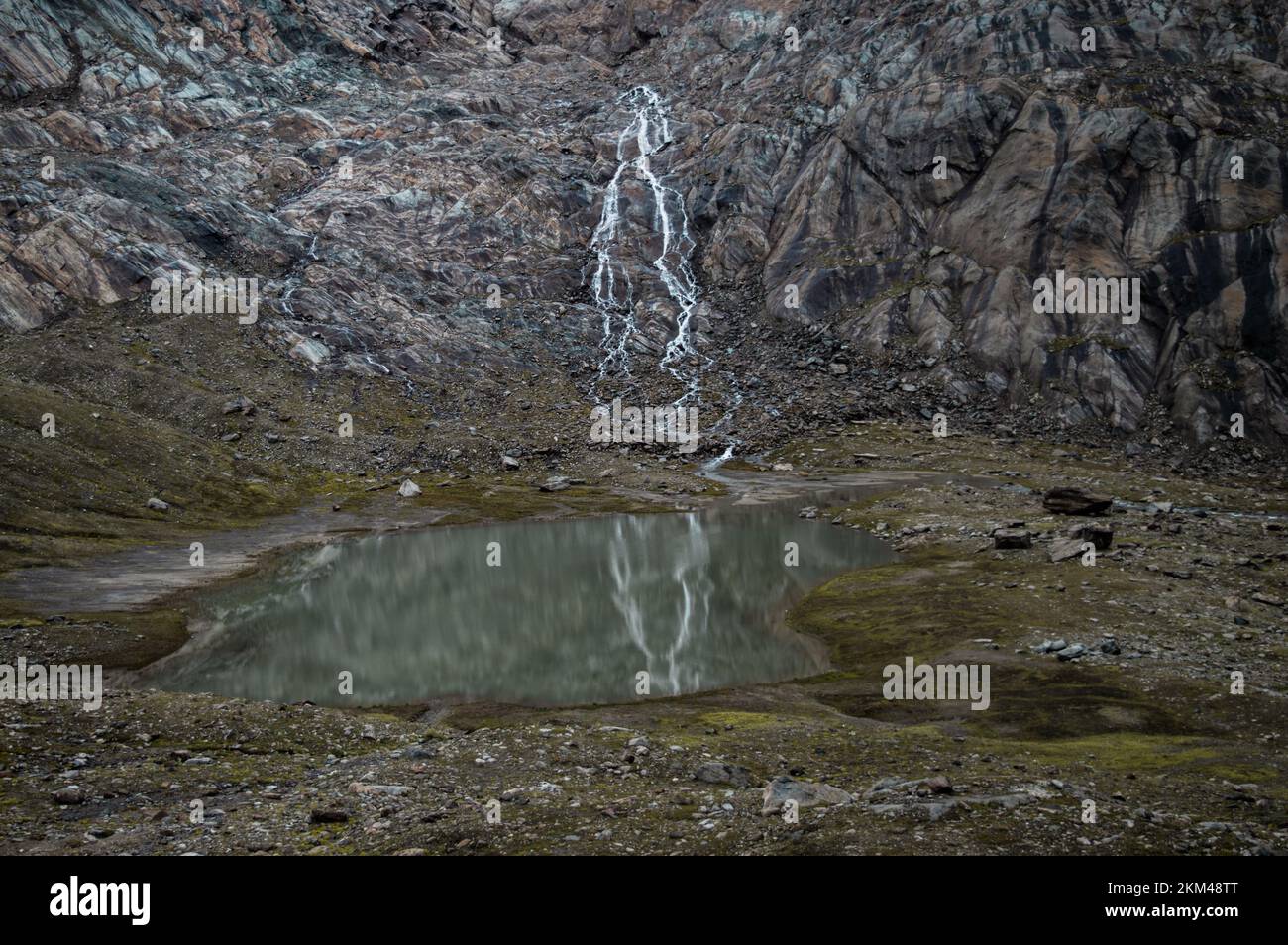 iced waterfall in the italian alps. dolomites waterfall Stock Photo - Alamy
