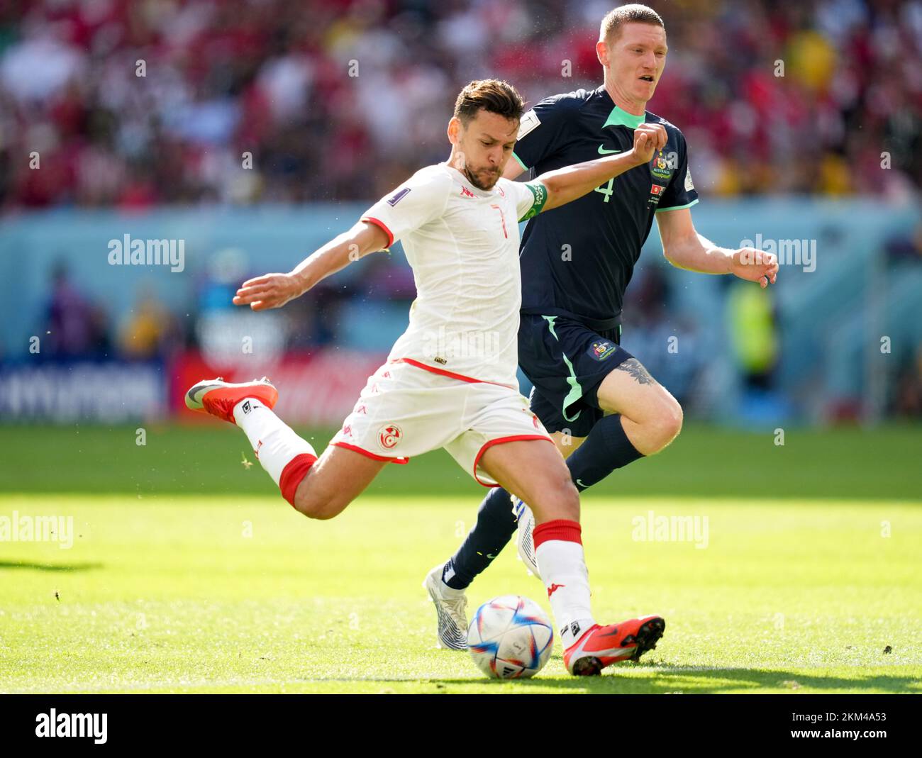Al Wakrah, Qatar. 26th Nov, 2022. Youssef Msakni (L) of Tunisia ...