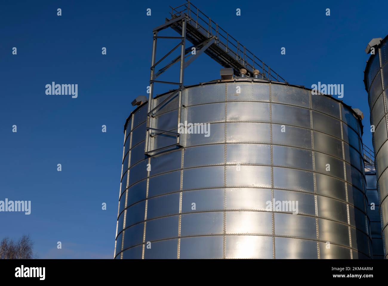 modern metal silo of large size, a silo at an agricultural enterprise ...
