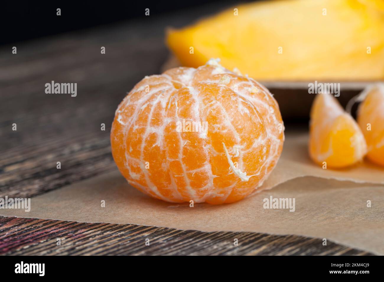 peeled ripe juicy tangerine, divided into slices of tangerine on a ...