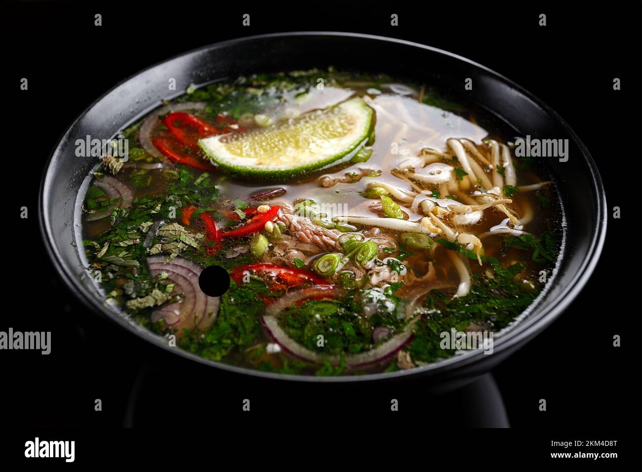 Fo-bo soup made of beef with spices and rice noodles, on a black ...