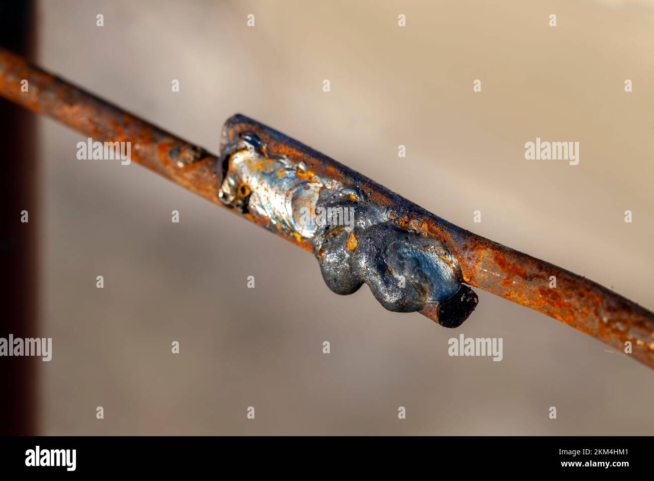 welded together metal fastening parts, part of a rustic fence made of ...