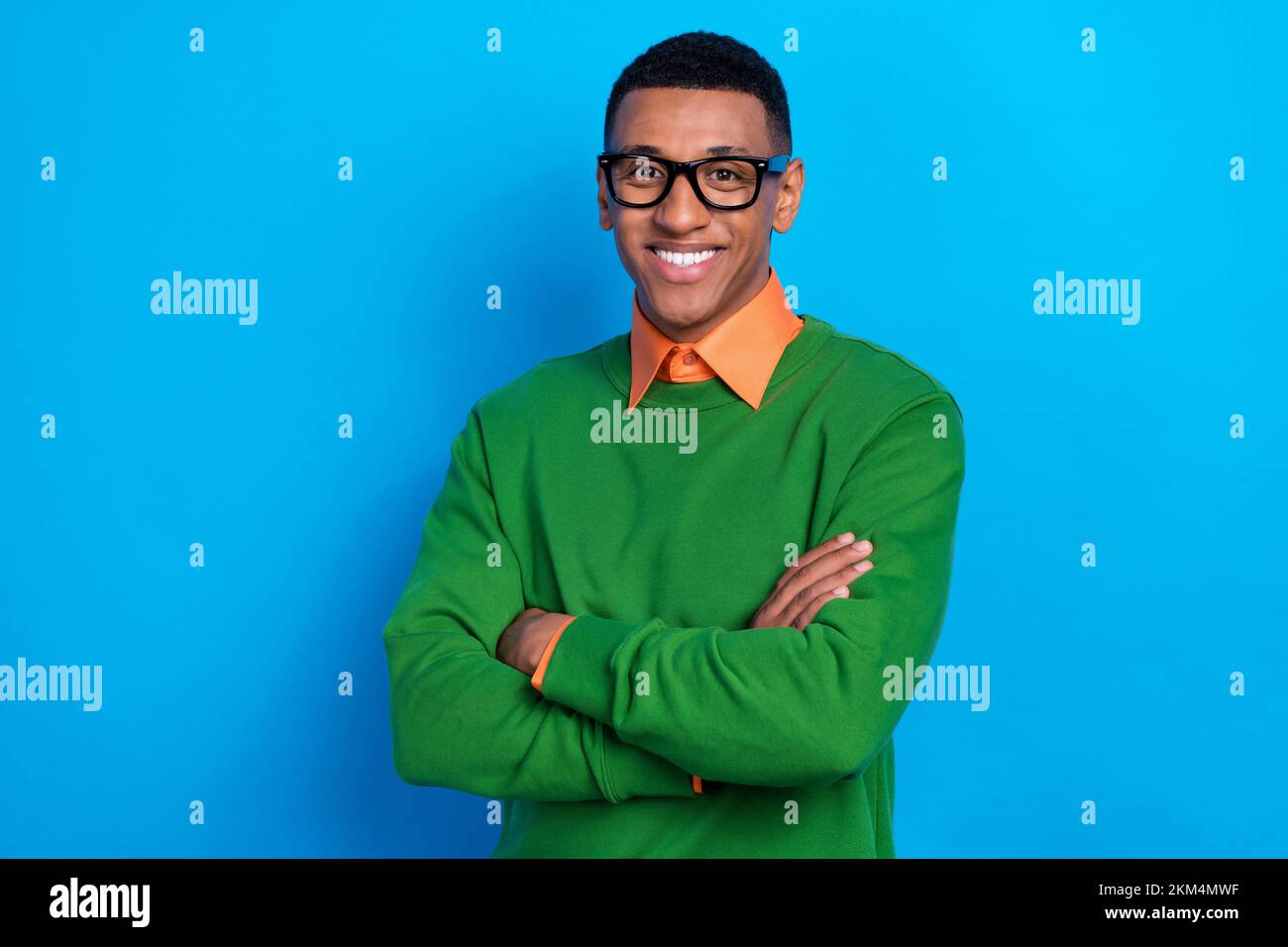 Photo of intelligent optimistic man dressed orange shirt under green ...