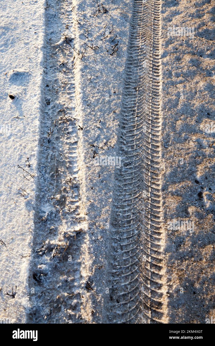 traces of cars in the snow in winter, snow with traces of vehicles on ...