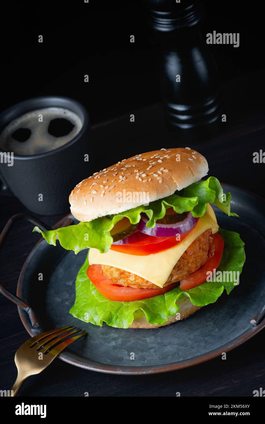 Fresh tasty burger on dark background Stock Photo - Alamy
