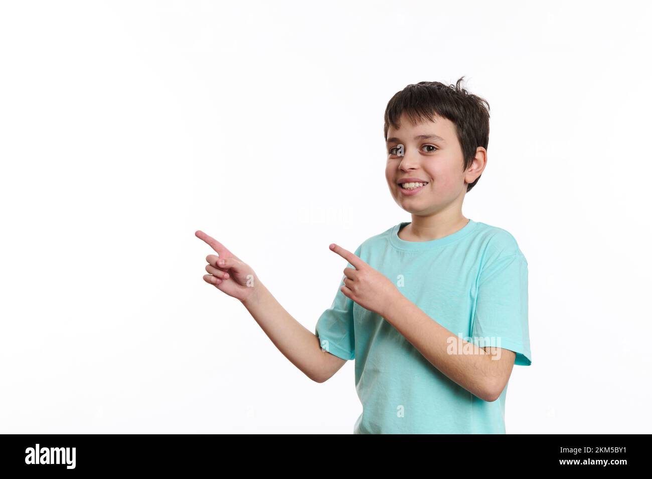 Portrait on white background of smart school boy, smiles looking at you ...