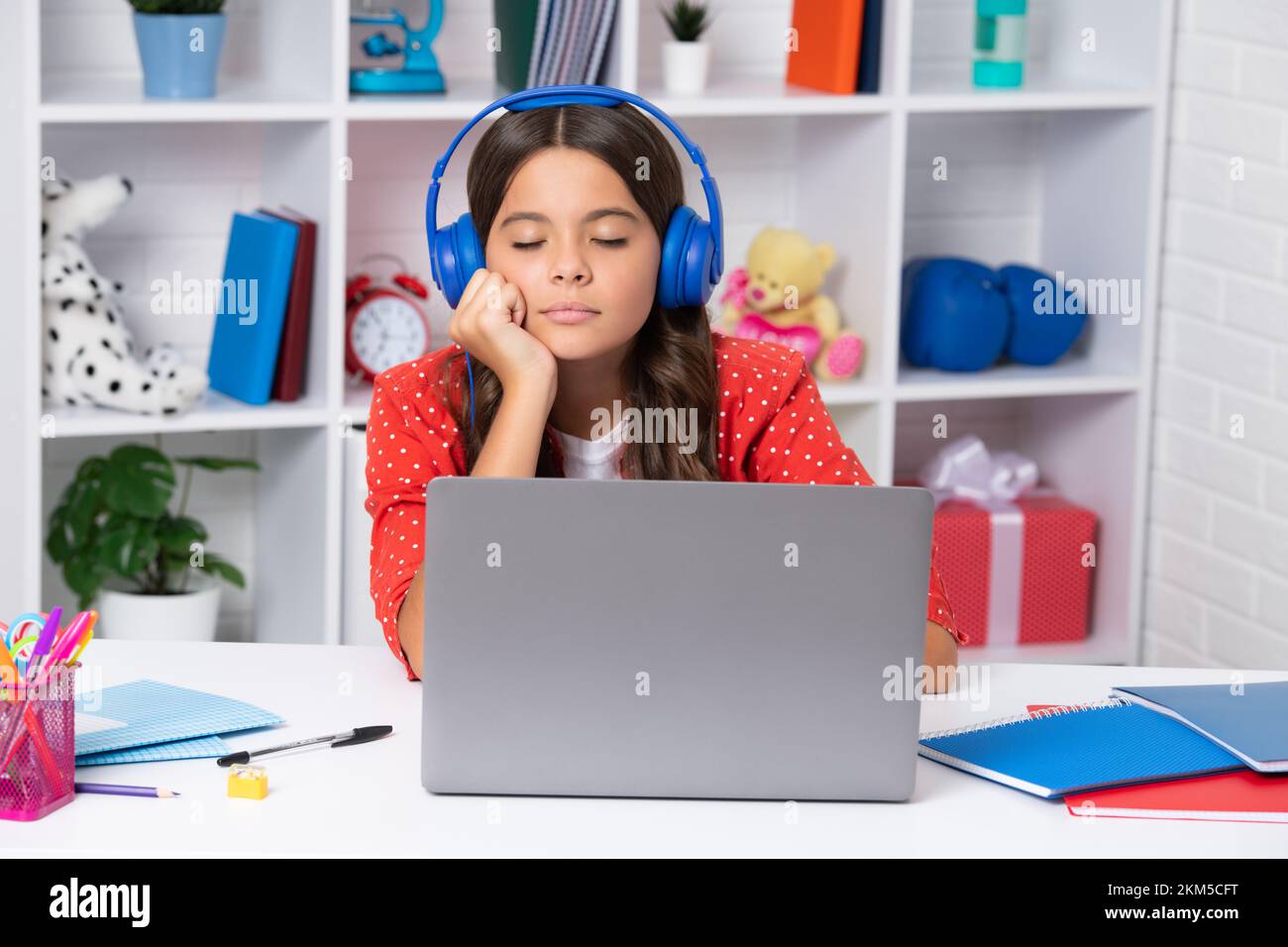 Tired and bored teenager girl. A young female student sitting at the ...
