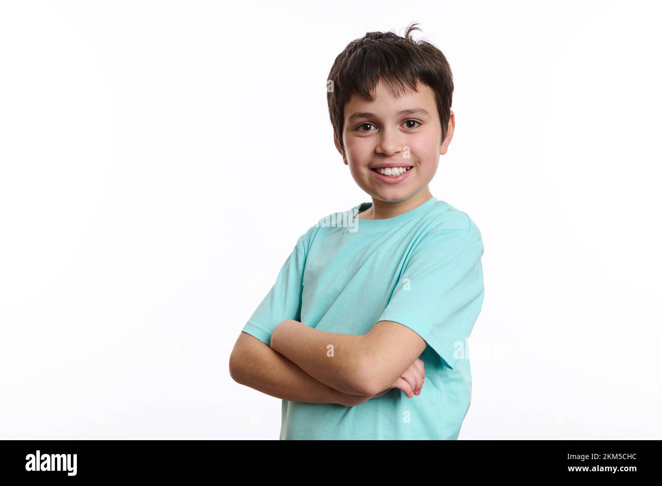 Lovely pre-adolescent boy smiling to camera with beautiful toothy smile ...