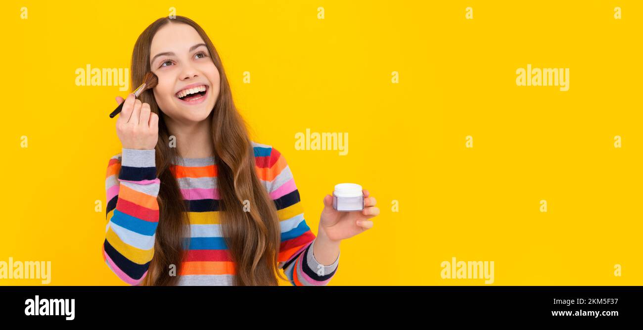 Happy kid apply cosmetics with powder brush yellow background, makeup ...