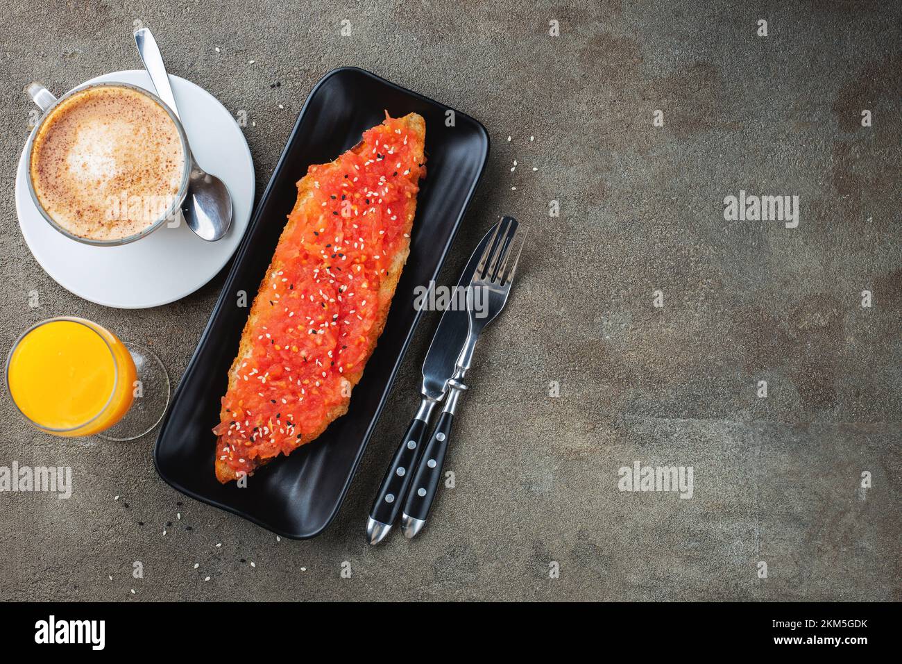 Traditional Spanish breakfast. Tostada with different toppings on a ...