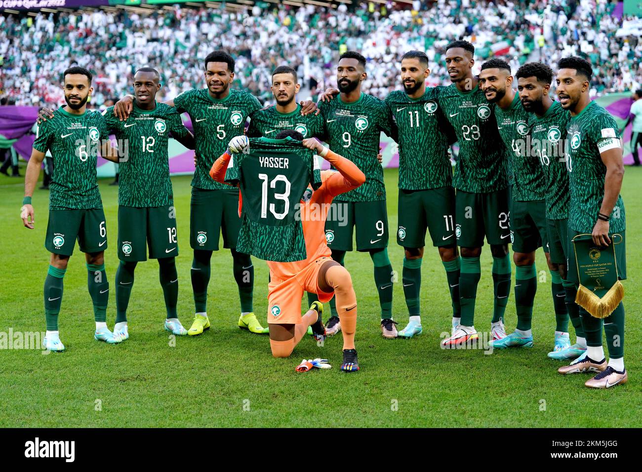 Saudi Arabia players pose with the shirt of team-mate Yasser Al ...