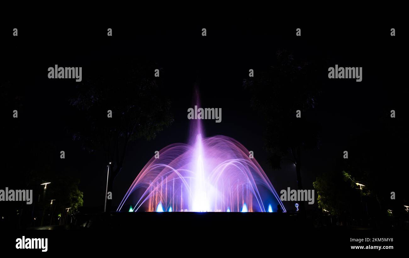 A night view of the glowing fountains in Puteri Harbour Iskandar ...