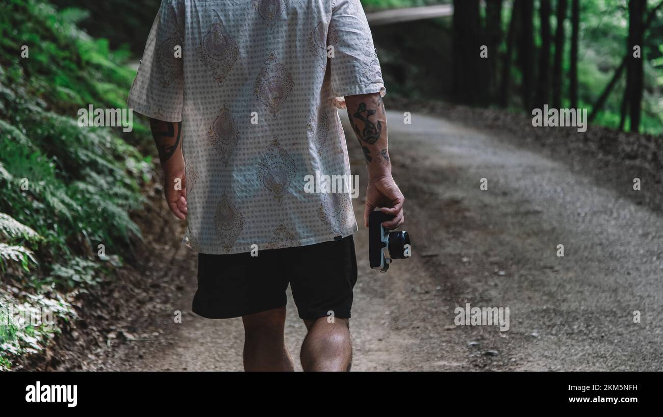 A man from behind photographing nature with a vintage camera Stock ...