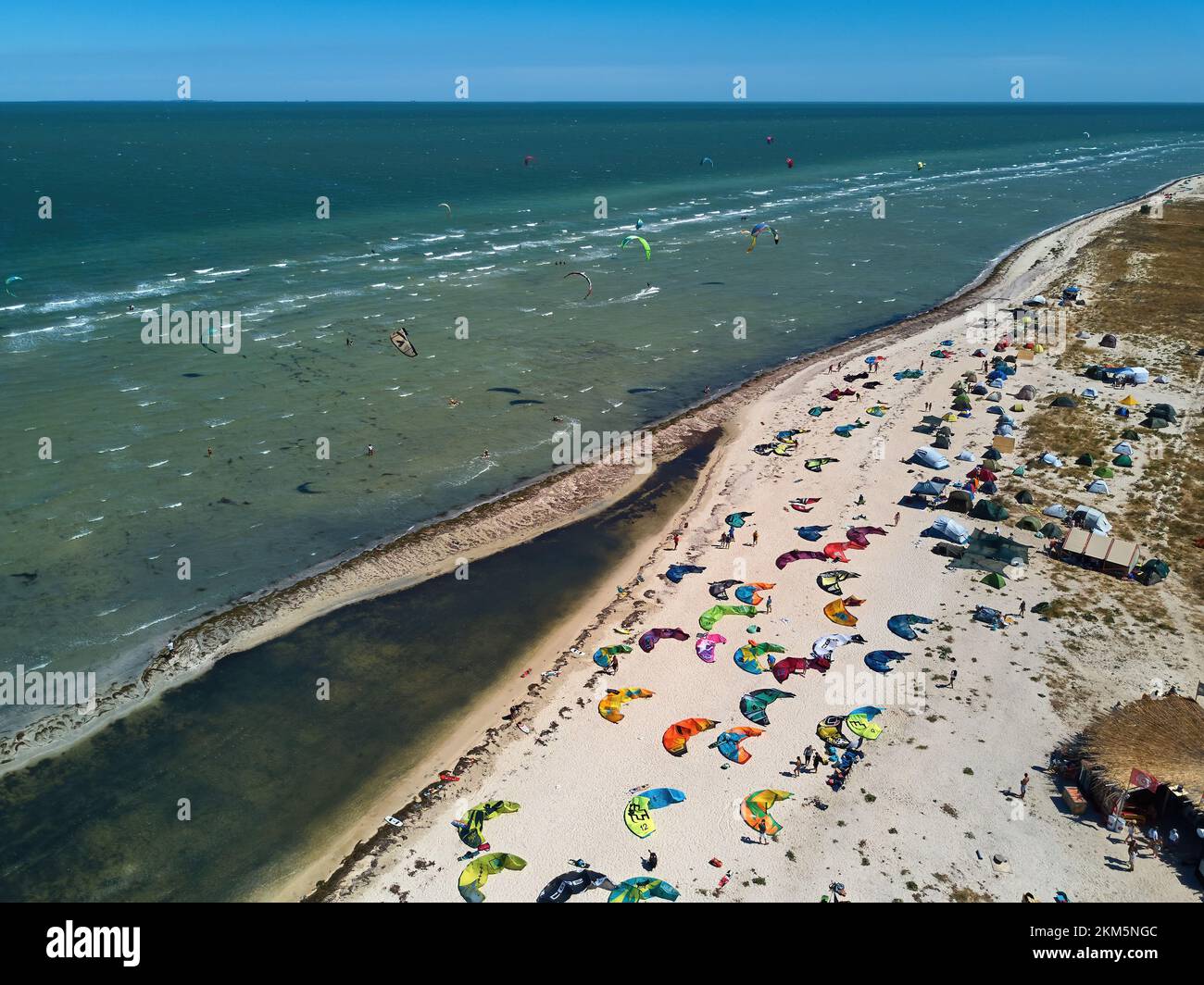 View from above of bright colorful kites lying parked on beach on windy ...