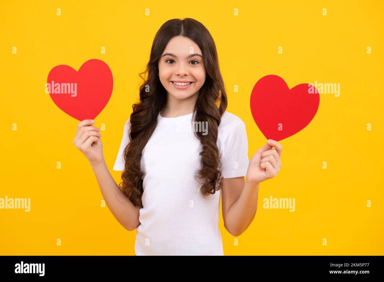 Teenage girl hold shape heart, heart-shape sign. Child holding a red ...