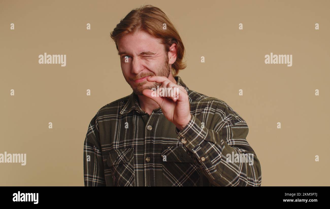 Need some more, please give me. Man showing a little bit gesture with ...