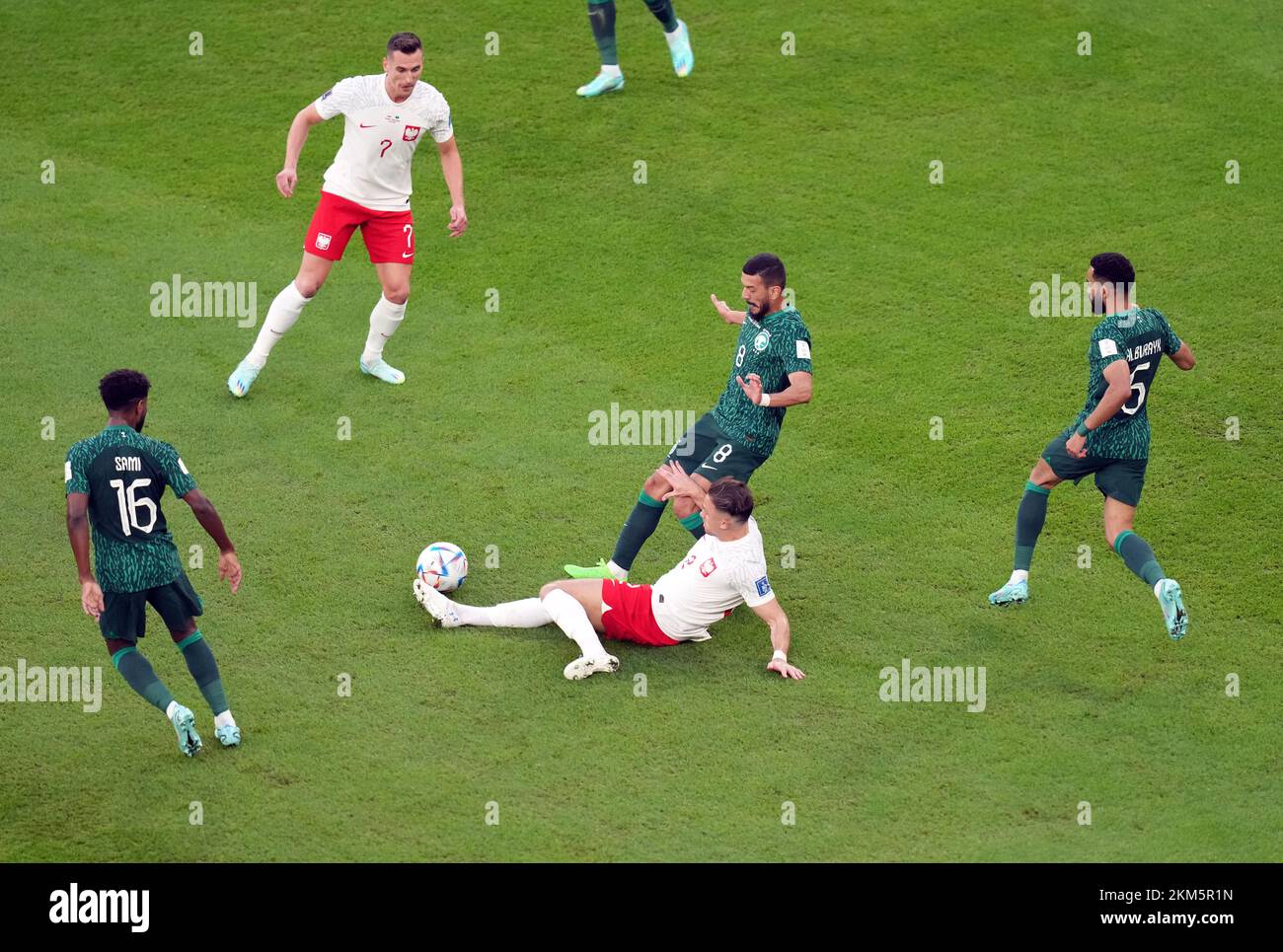 Poland’s Matty Cash tackles Saudi Arabia's Abdulellah Al-Malki during ...