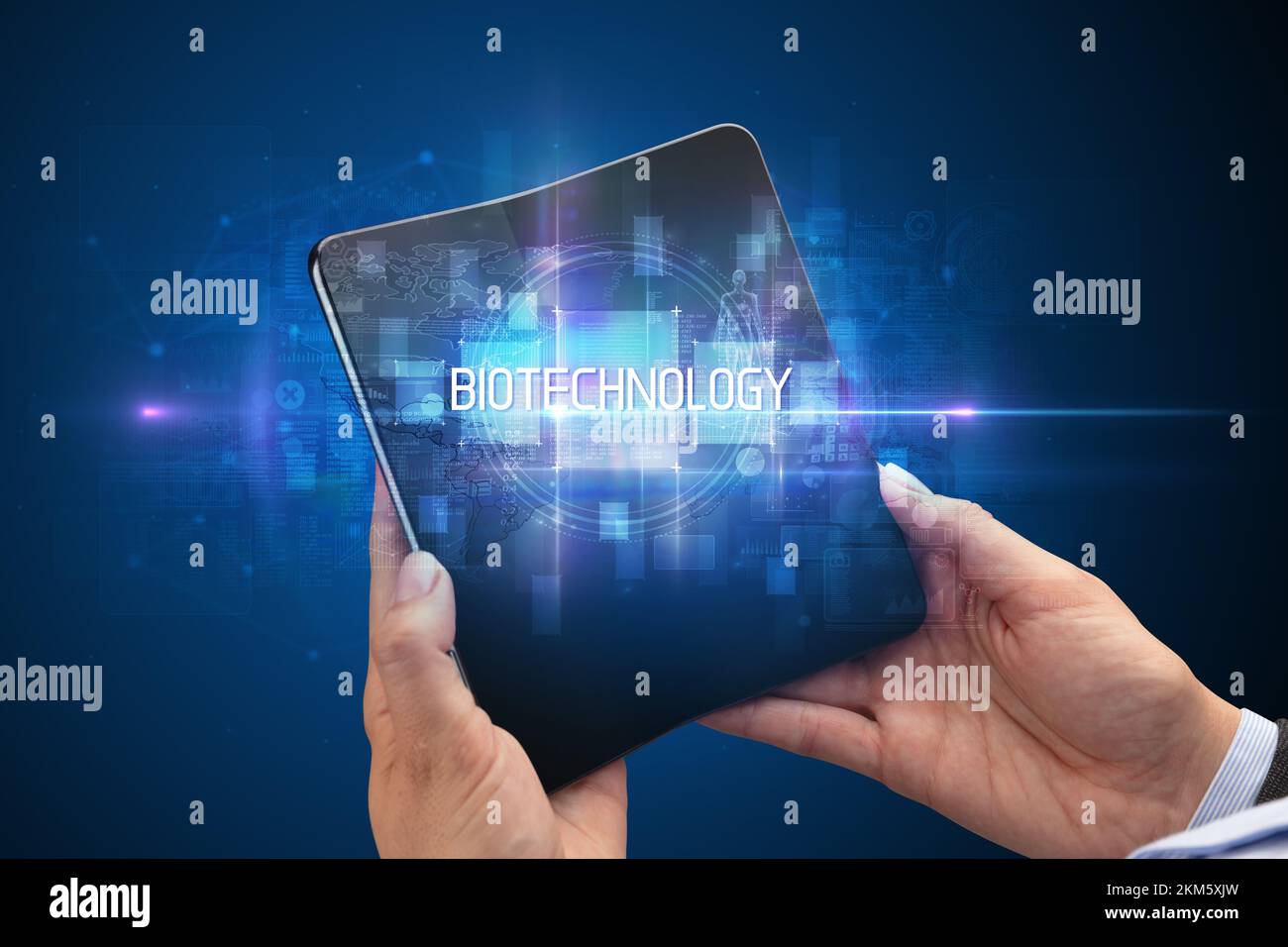 Businessman holding a foldable smartphone Stock Photo - Alamy