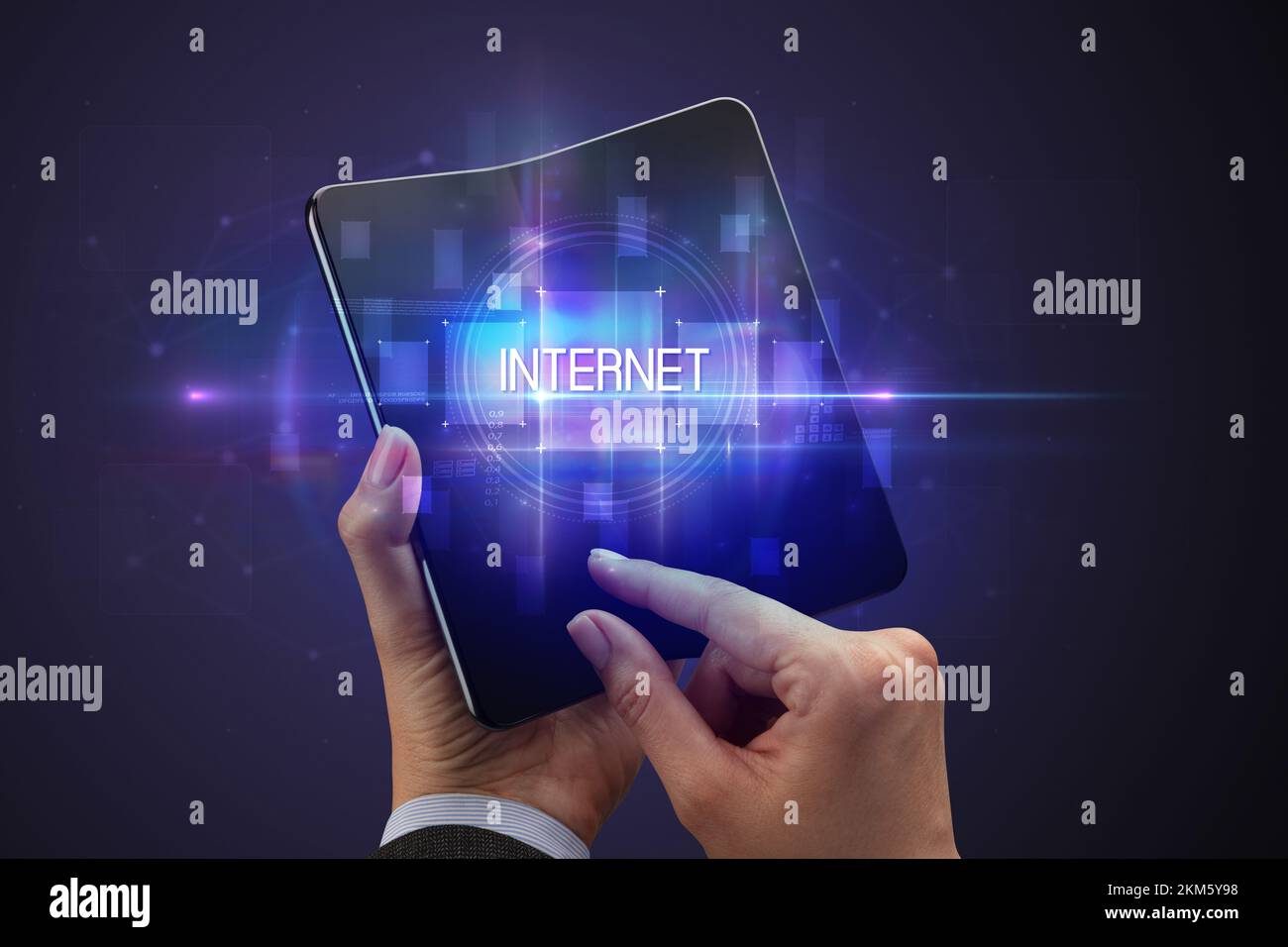 Businessman holding a foldable smartphone Stock Photo - Alamy