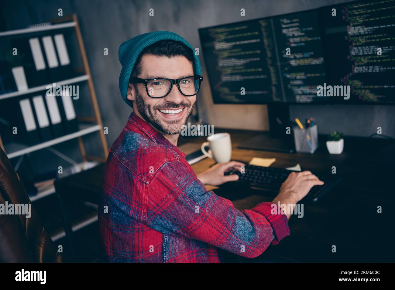 Photo of cheerful happy freelancer wear hat glasses smiling working ...