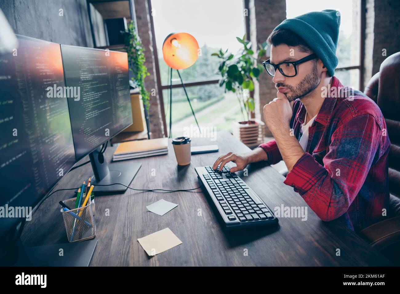 Photo of smart intelligent coder dressed hat glasses writing ...